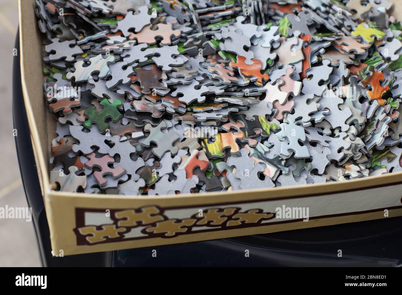 Puzzle pieces mixed in a box Stock Photo - Alamy