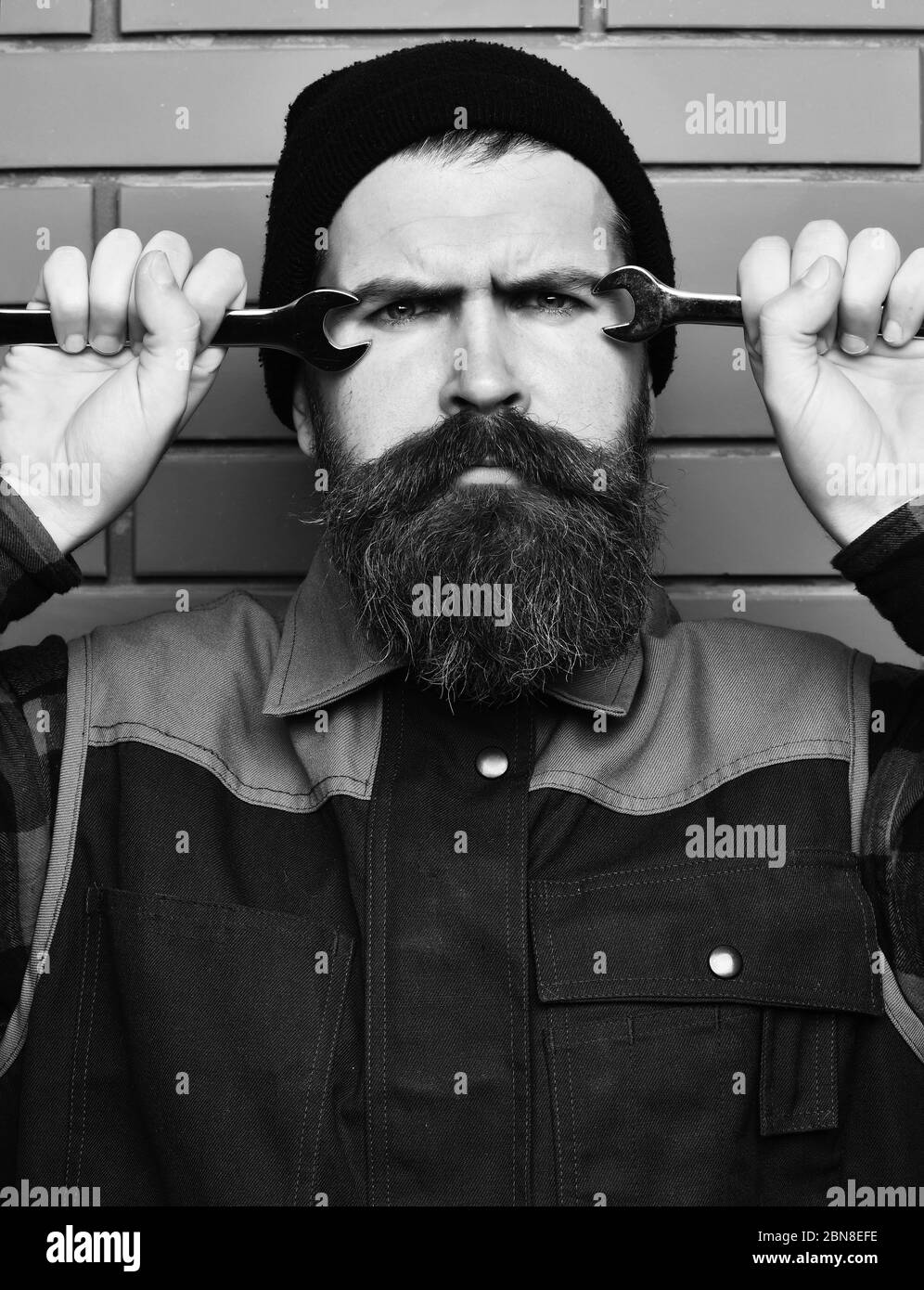 Bearded man, long beard. Brutal caucasian serious mechanic, unshaven ...