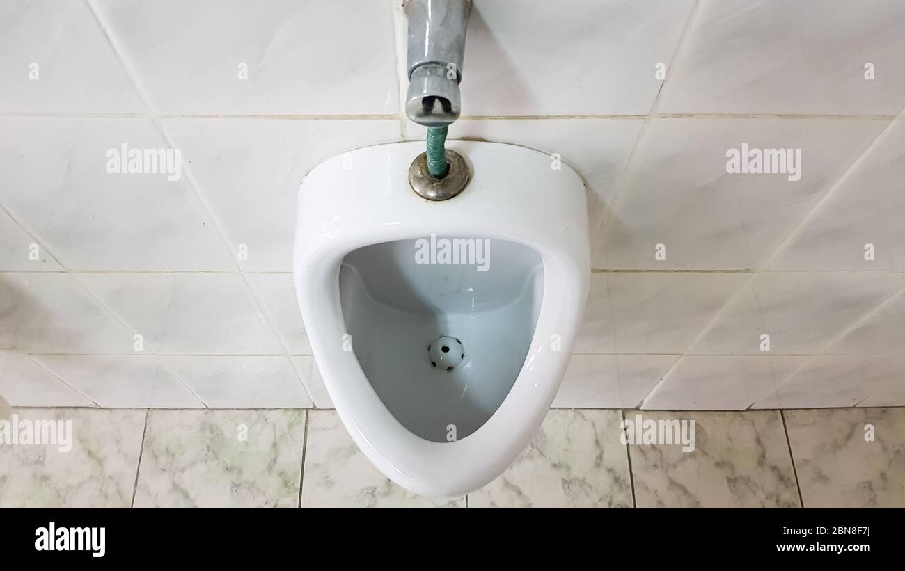Public toilet with one ceramic urinal. Urinals prepare bowls for men ...
