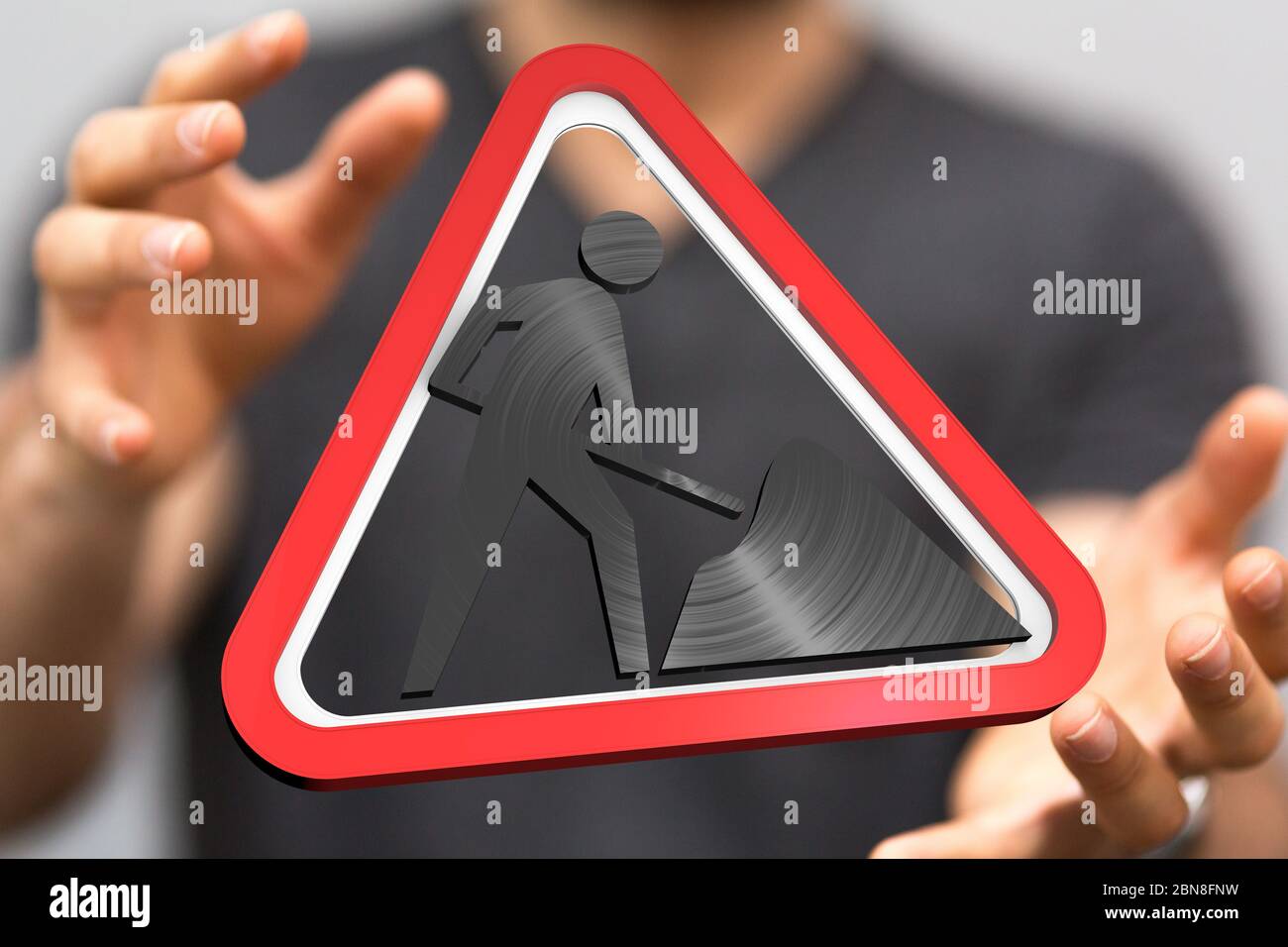 A under process sign in hand Stock Photo - Alamy