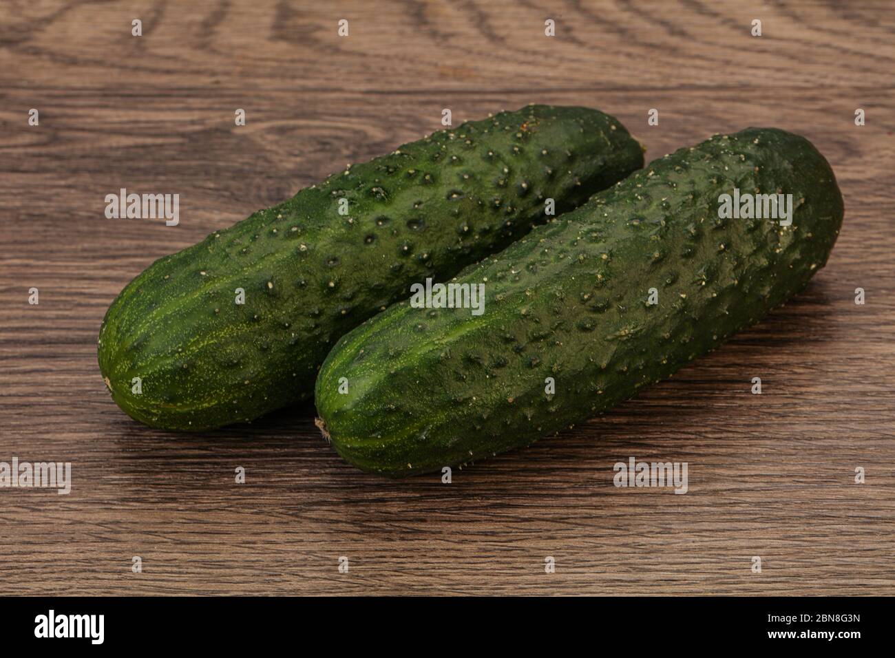 Green fresh two cucumbers over background Stock Photo - Alamy
