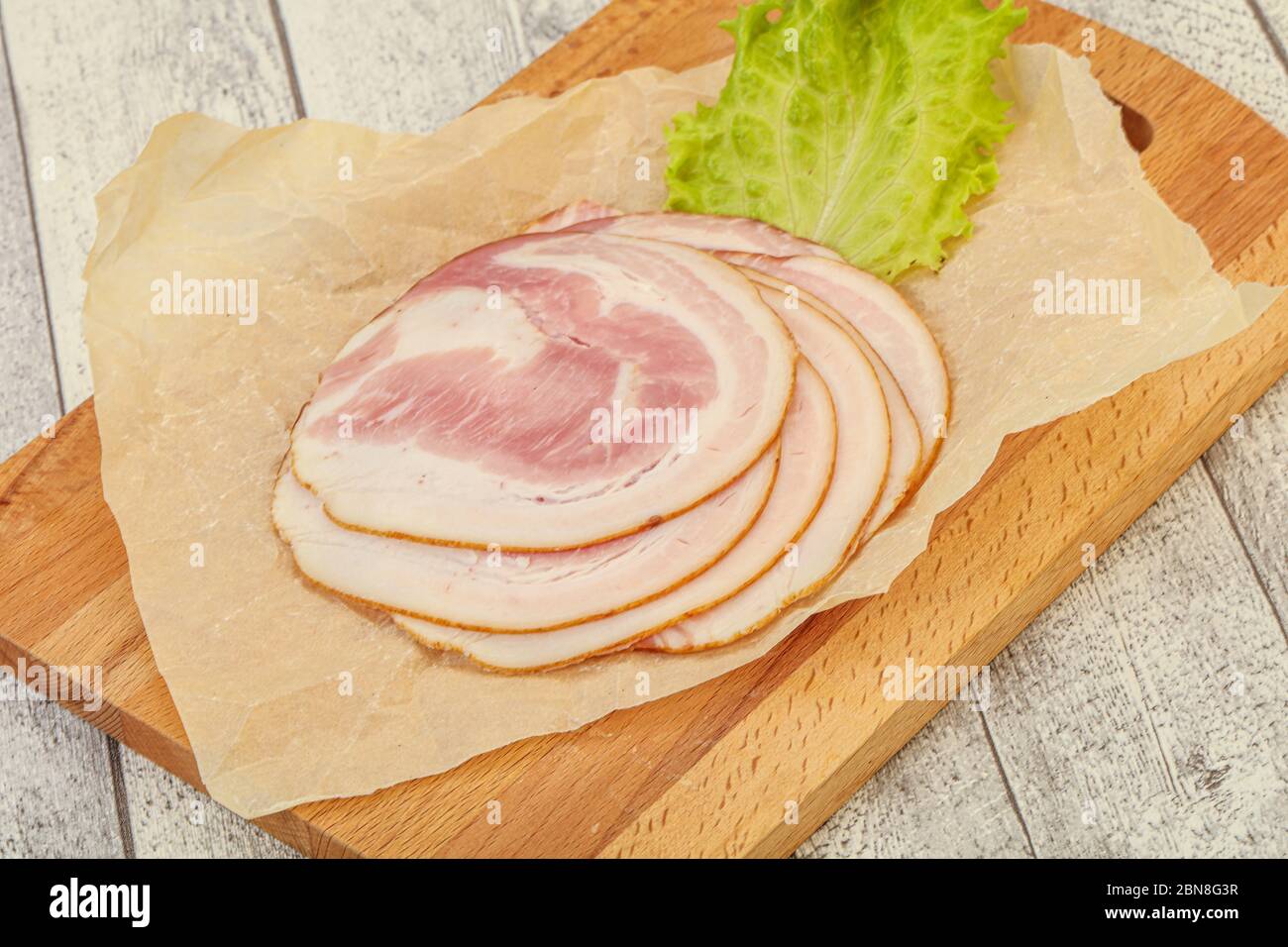 Sliced Italian Pancetta sausage over board Stock Photo - Alamy
