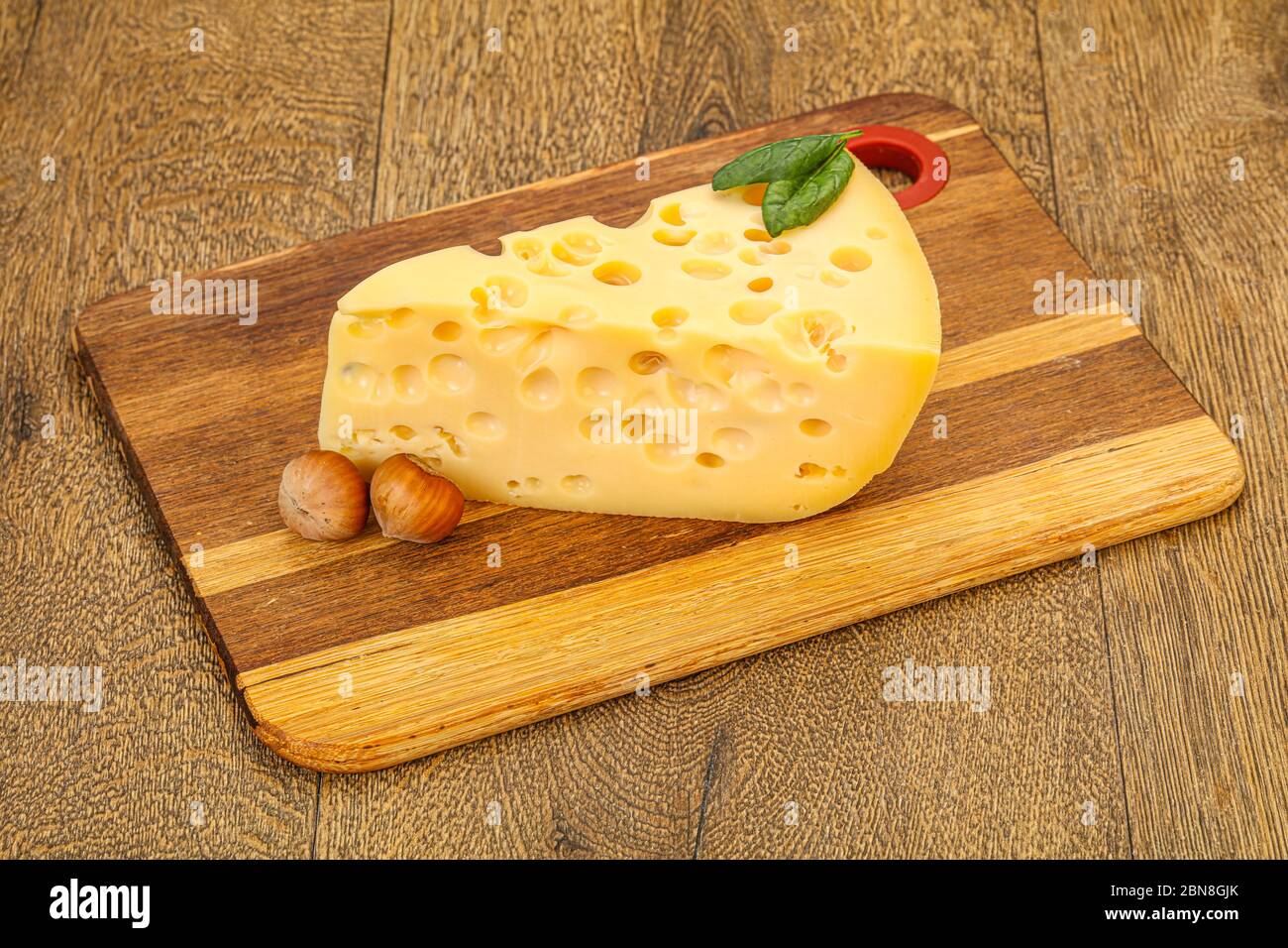 Maasdam cheese - dairy yellow triangle with holes Stock Photo - Alamy