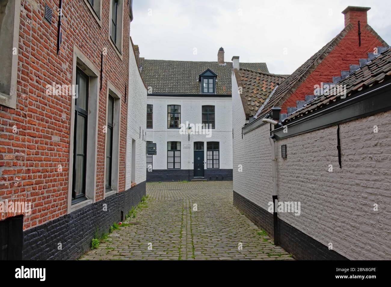 Cobblestone streets with small cosy white painted brick houses of the ...