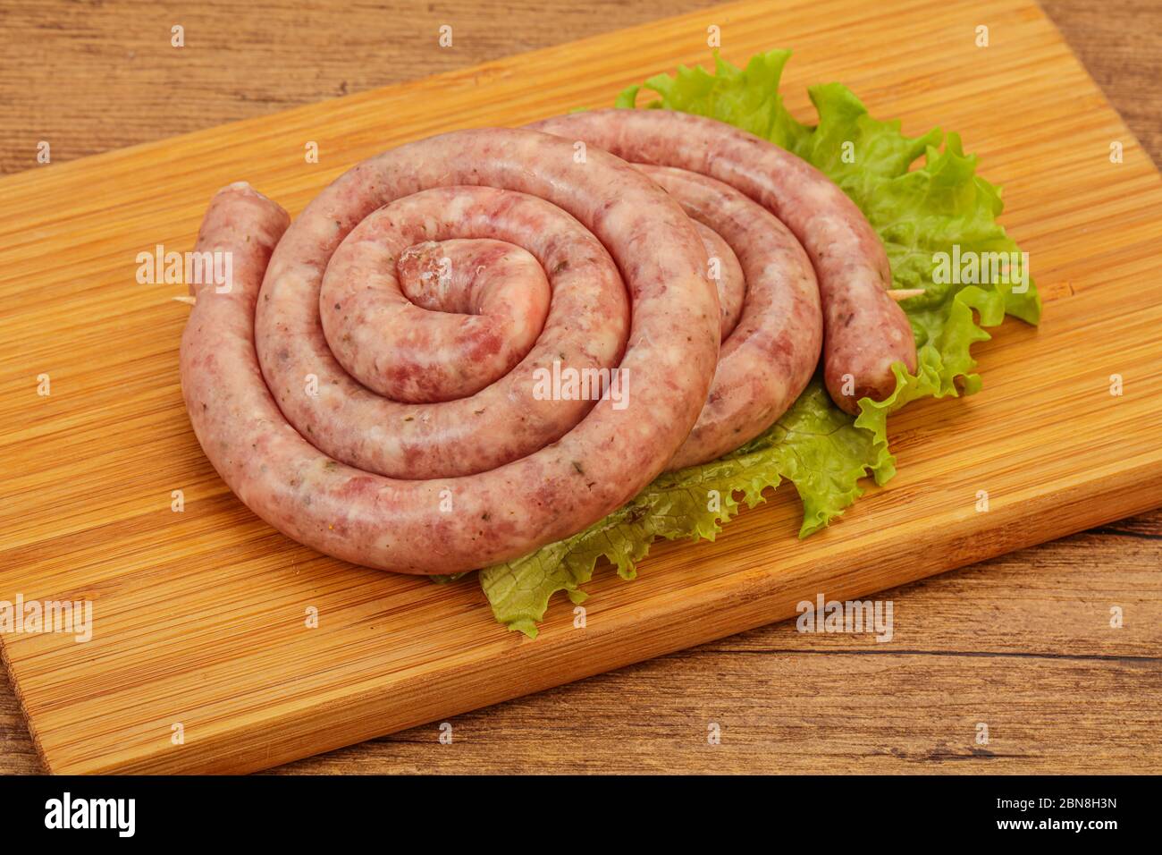 Raw pork sausage ring for grill Stock Photo - Alamy