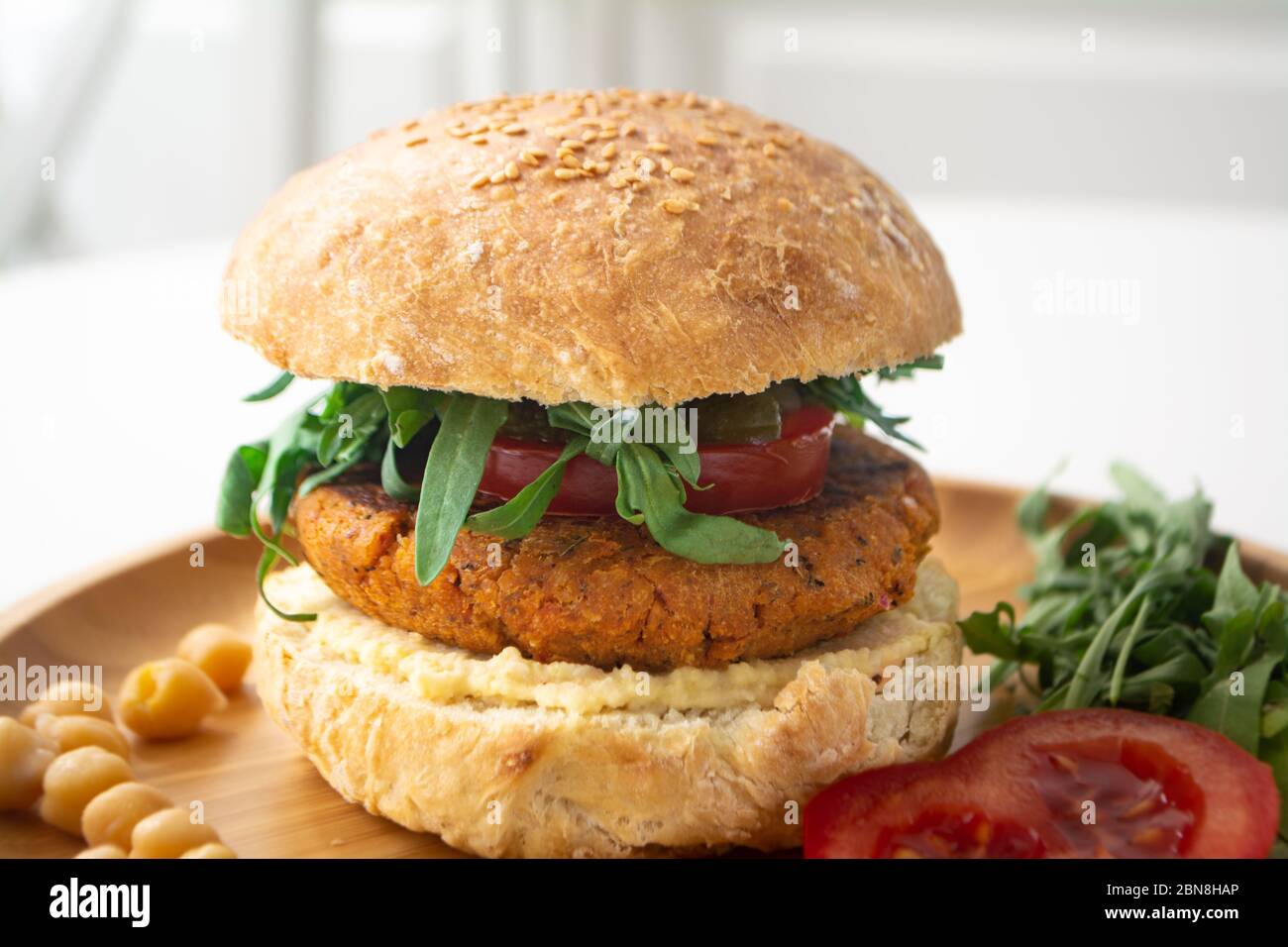 Vegan falafel hummus burger with homemade sourdough bun, tomatoes ...