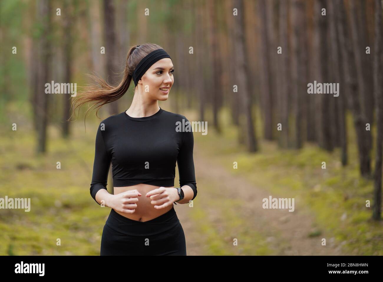 Pretty young girl runner in the forest. Running woman. Female runner ...