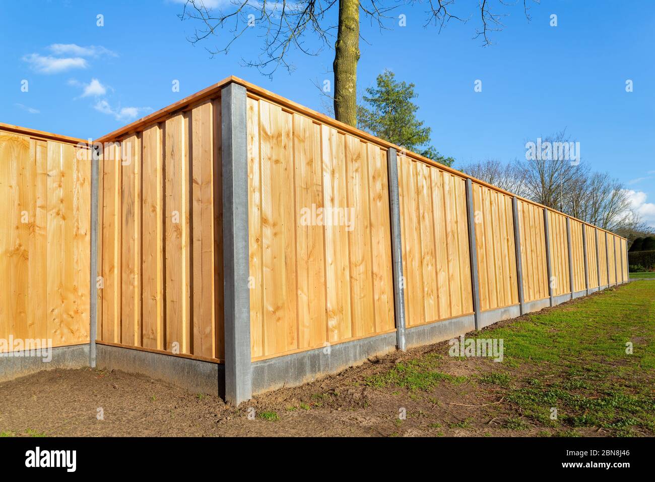 Outside built new wooden fence construction surrounding dutch garden ...