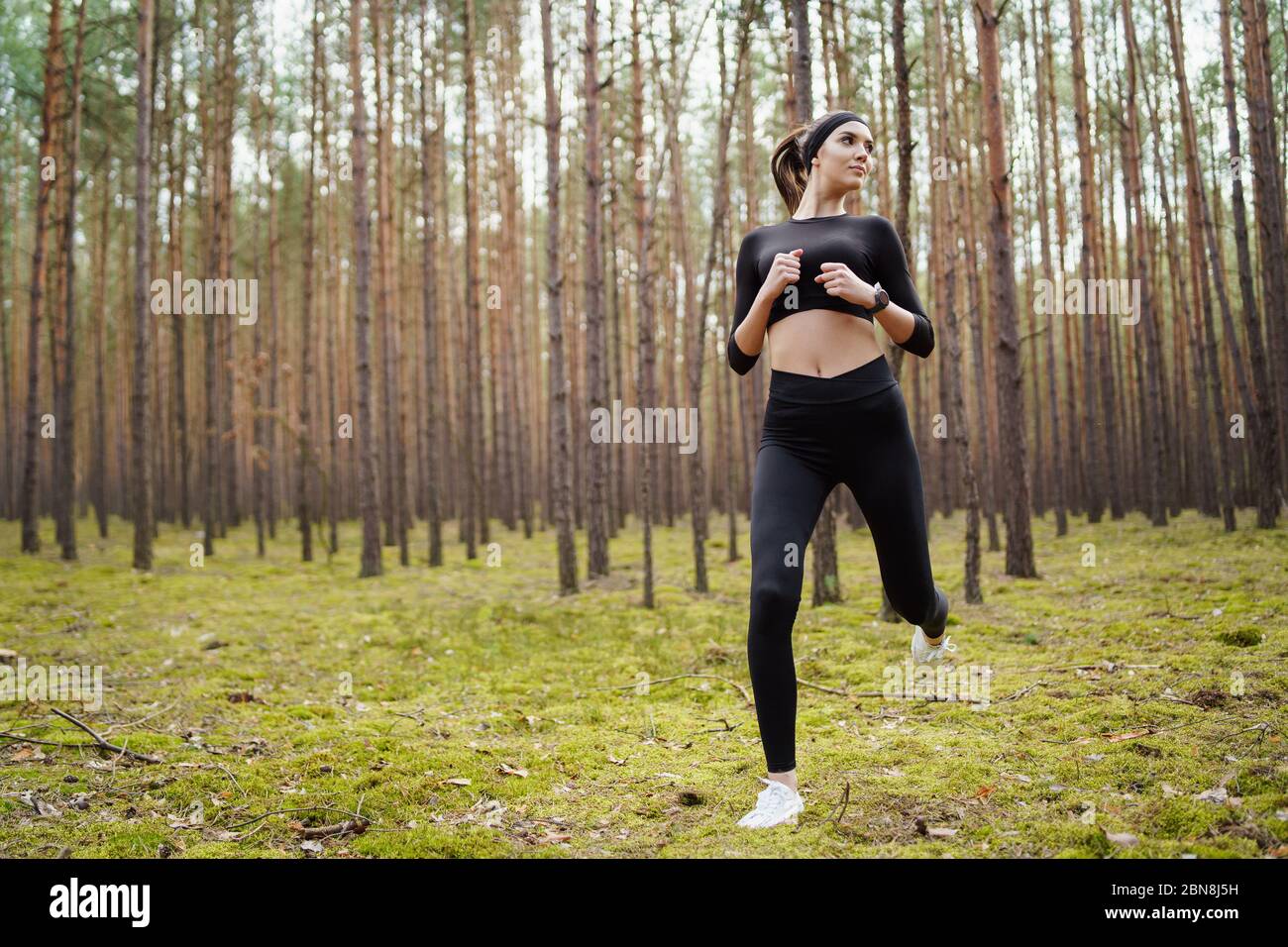 Teenager running in nature. Pretty young girl runner in the forest ...