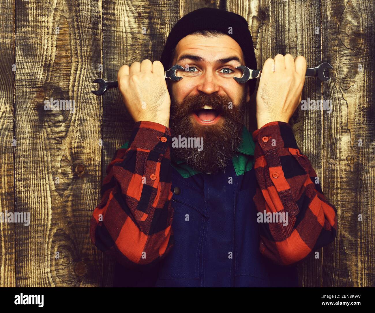 Bearded man, long beard. Brutal caucasian mechanic, smiling happy ...