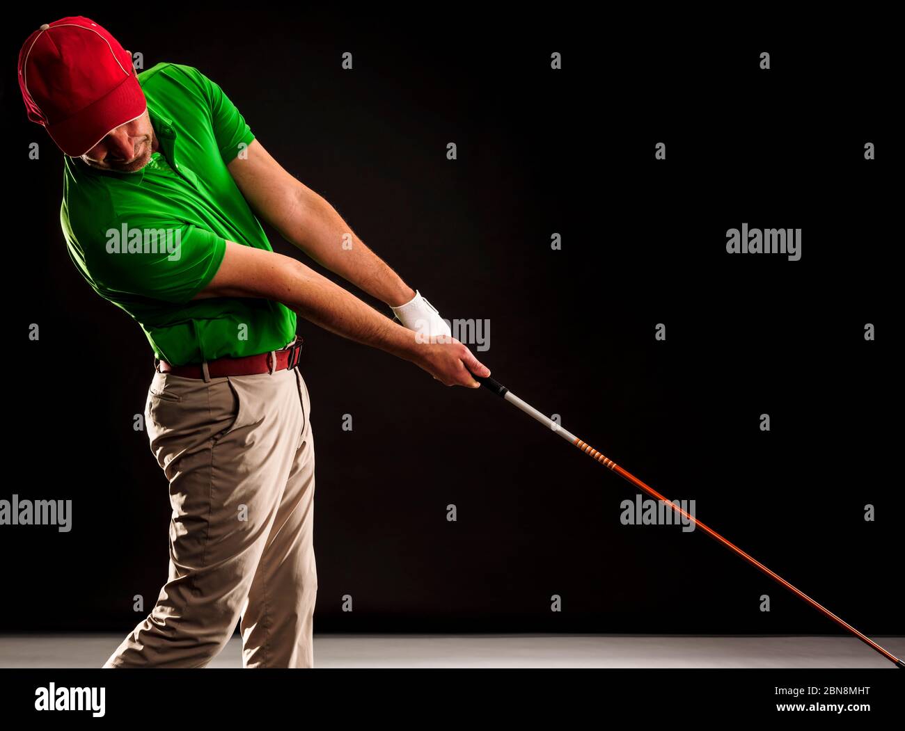 Portrait of a golf player hitting the perfect golf shot isolated on ...