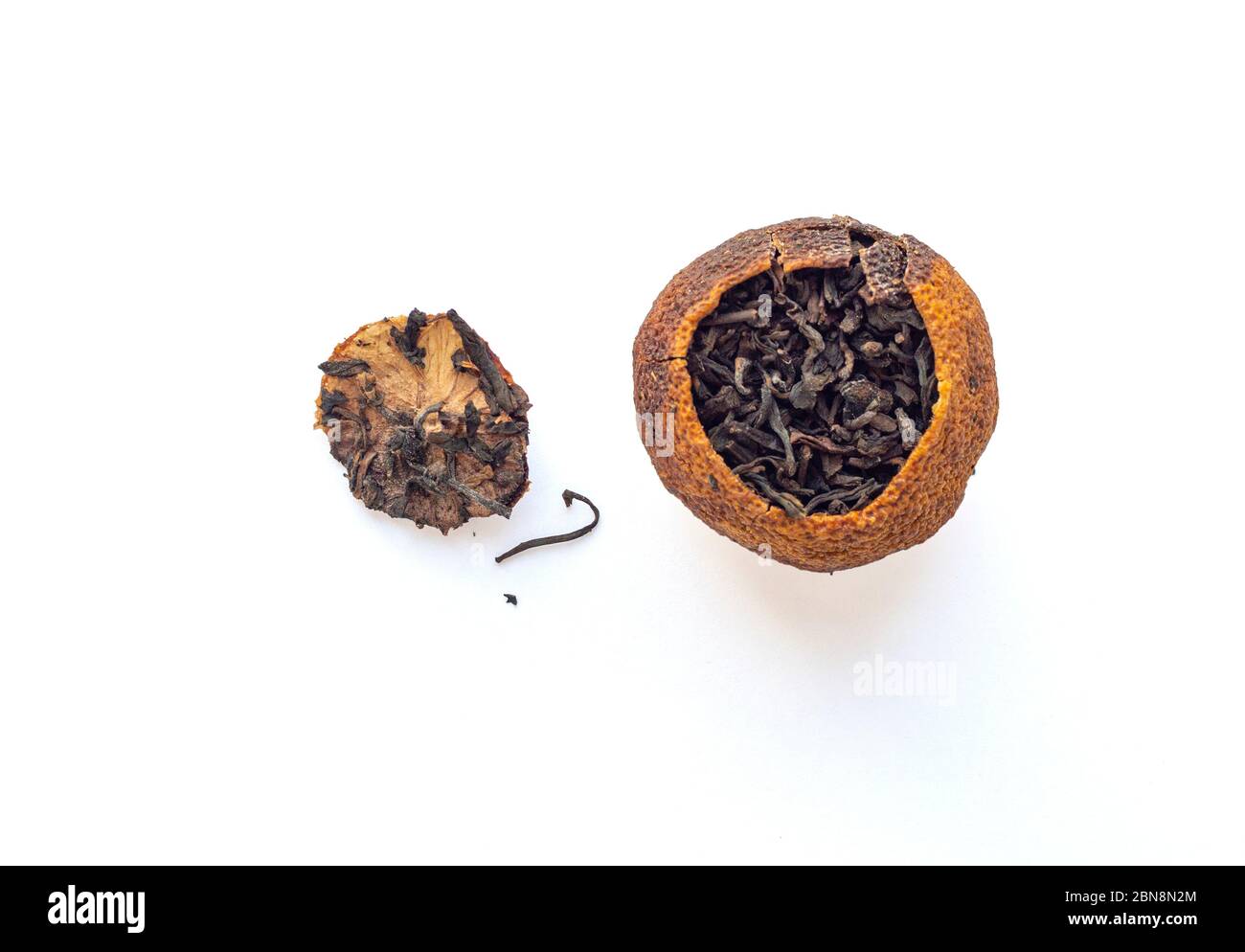 Chinese dark tea Pu-erh packed in dried mandarin peel isolated on white ...