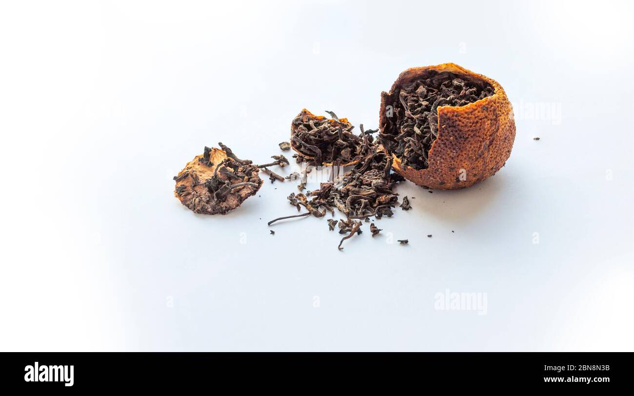 Chinese dark tea Pu-erh packed in dried mandarin peel isolated on white ...