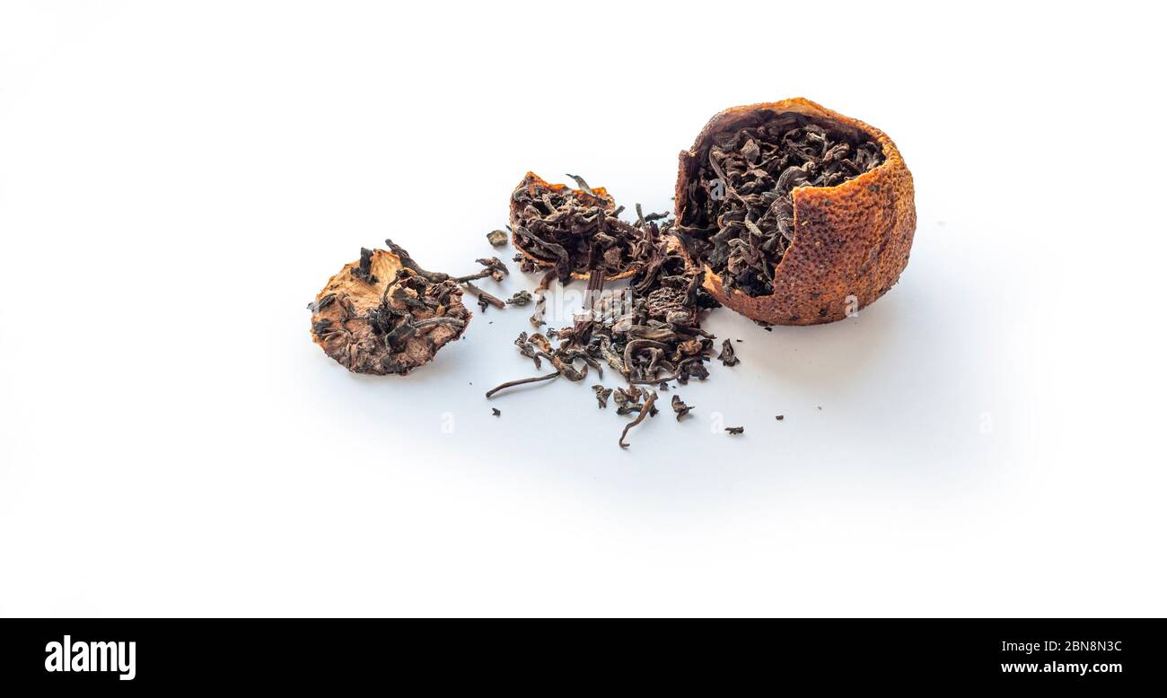 Chinese dark tea Pu-erh packed in dried mandarin peel isolated on white ...
