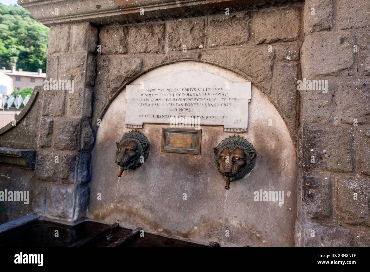 Lion head Fountain with bronze plaque in Nemi, Metropolitan City of ...