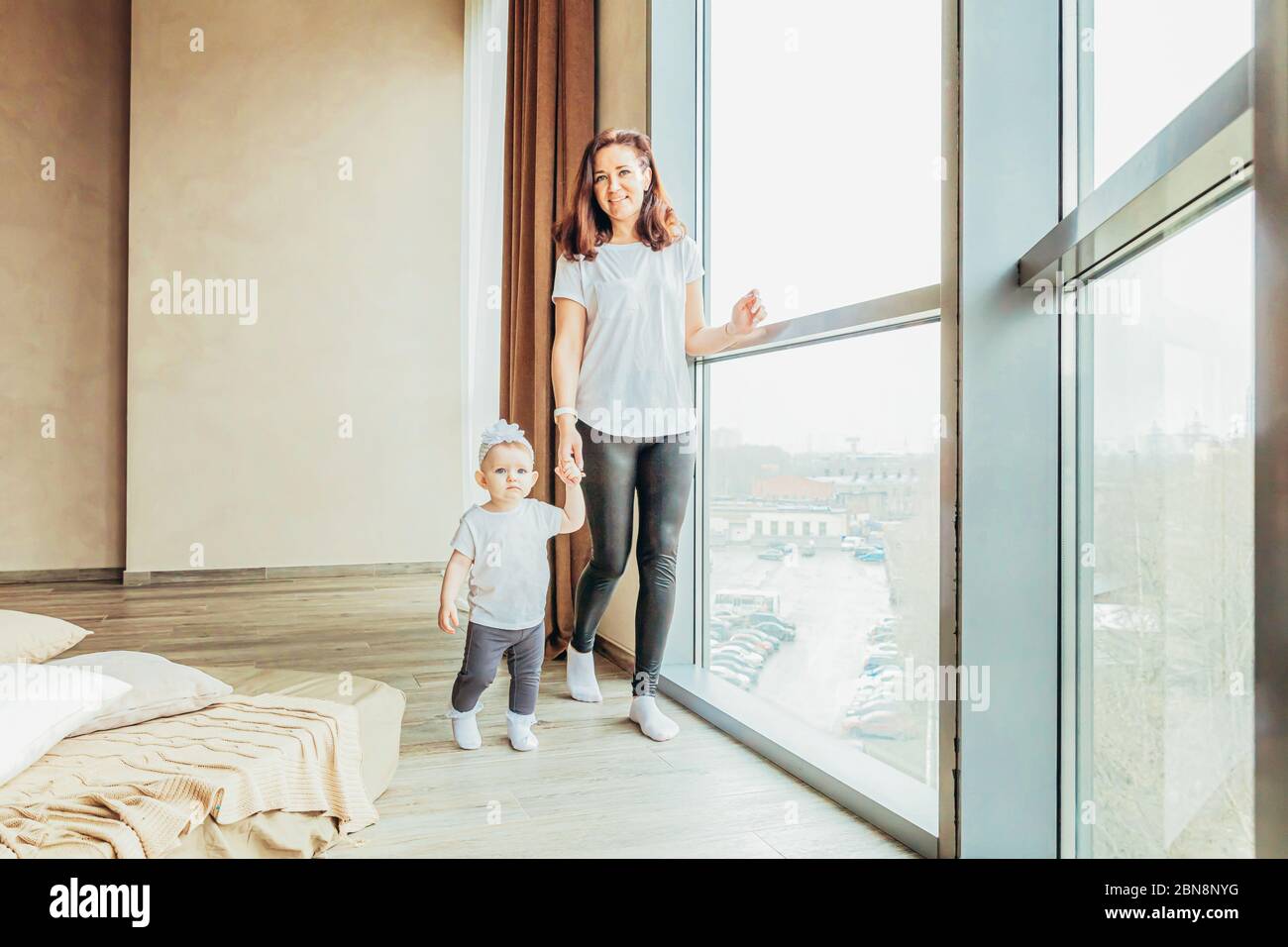 Stay Home Stay Safe. Young mother holding her child. Woman and infant ...