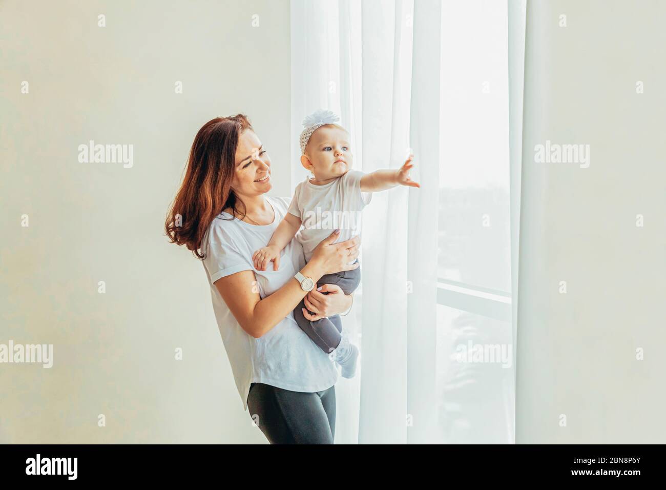 Stay Home Stay Safe. Young mother holding her child. Woman and infant ...