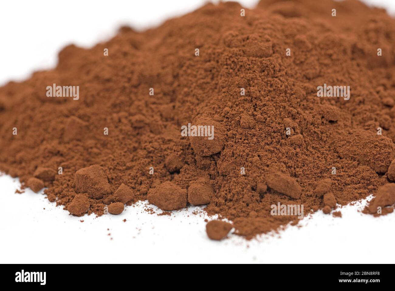 Cocoa powder isolated against a white background Stock Photo - Alamy