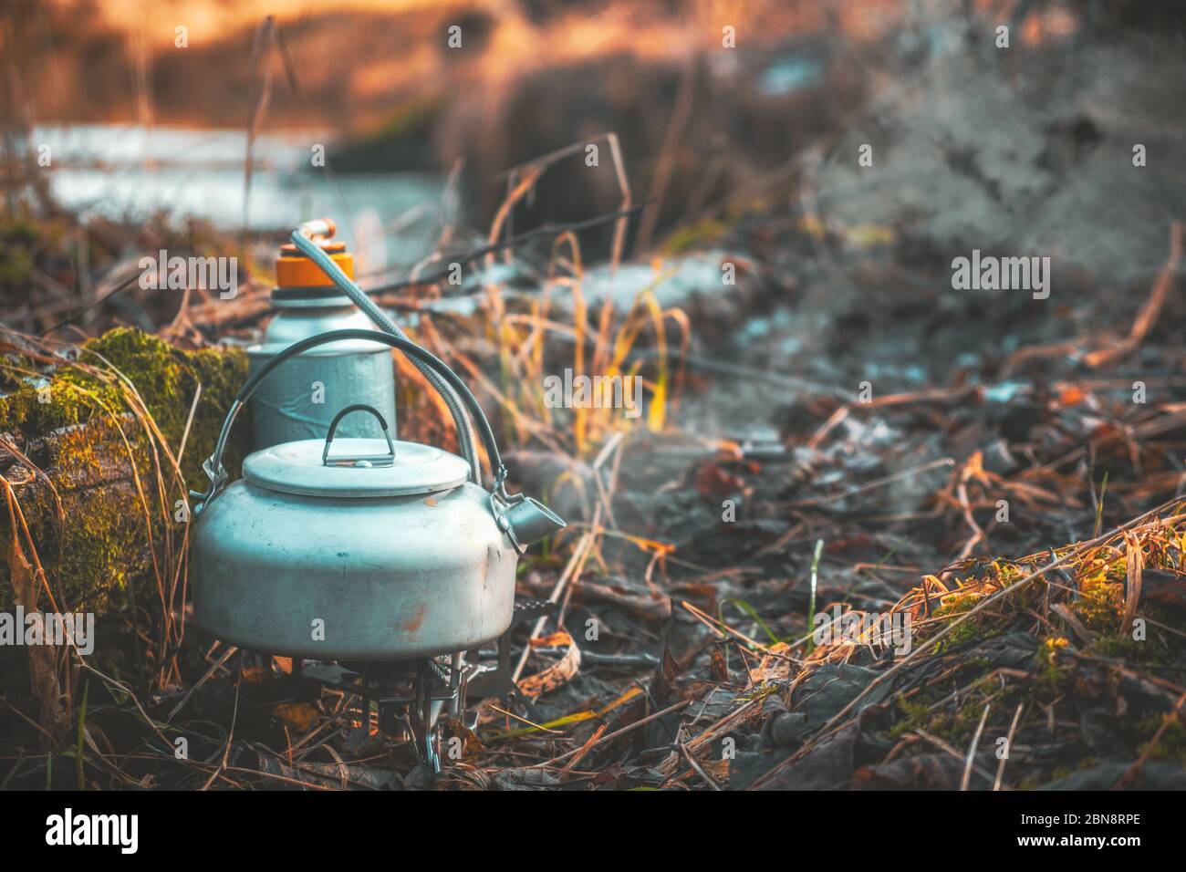 Make tea on a gas burner. Hiking with a backpack Stock Photo - Alamy