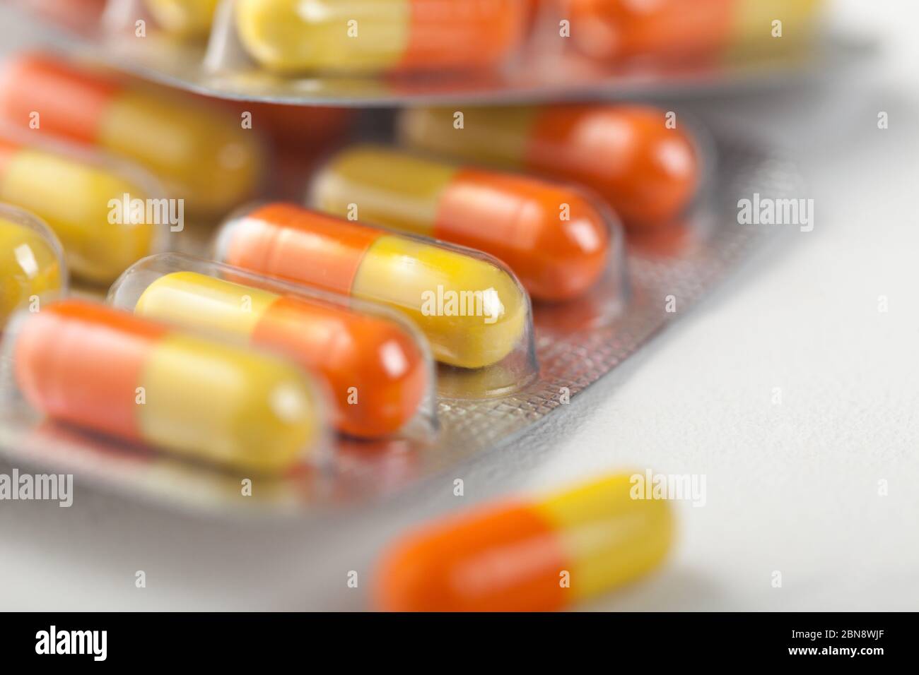 Pills capsule in plastic strip on white. Antibiotics, vitamins ...