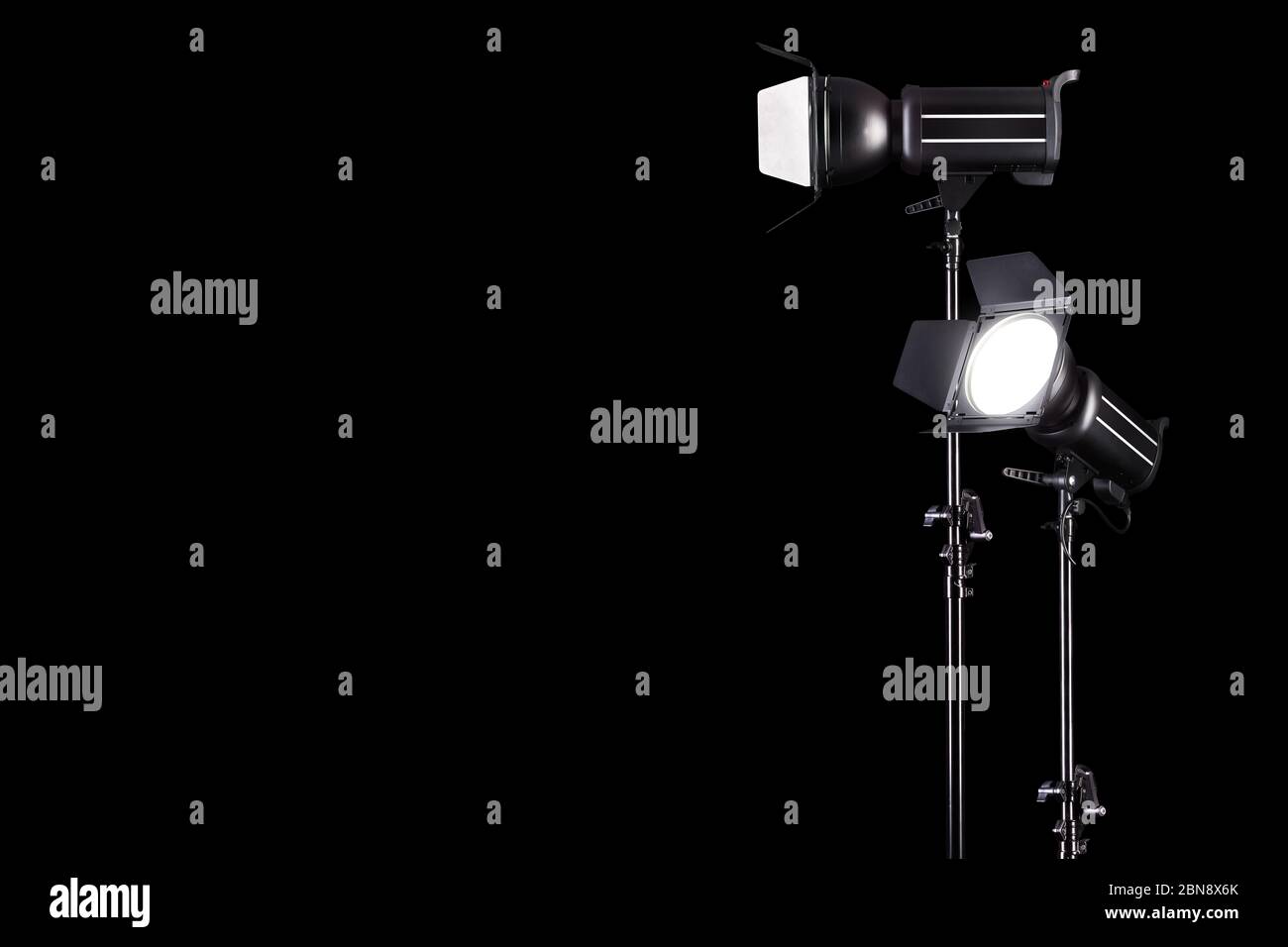 Photography studio flash on a lighting stand isolated on black ...