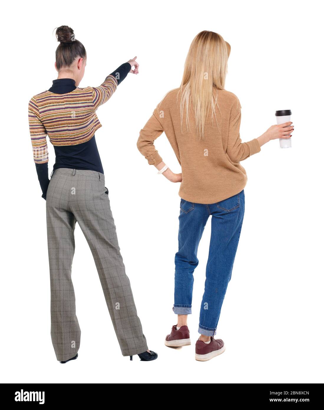 Back view of two pointing girl in sweater. Rear view people collection ...