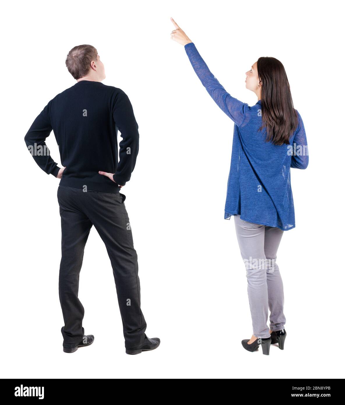 Back view of couple in sweater pointing. Rear view people collection ...