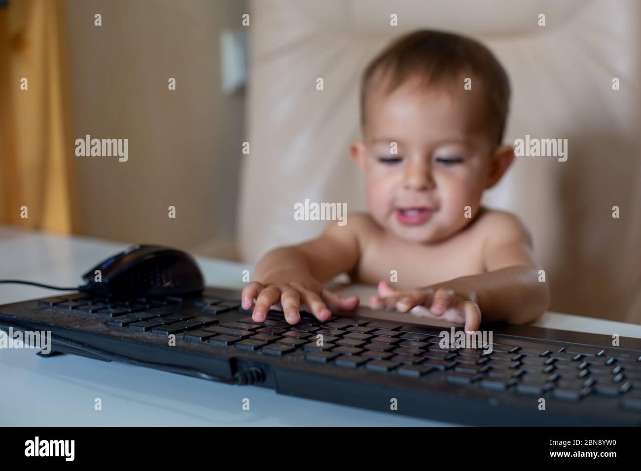 close up of baby fingers on keyboard.on backround cute little baby ...