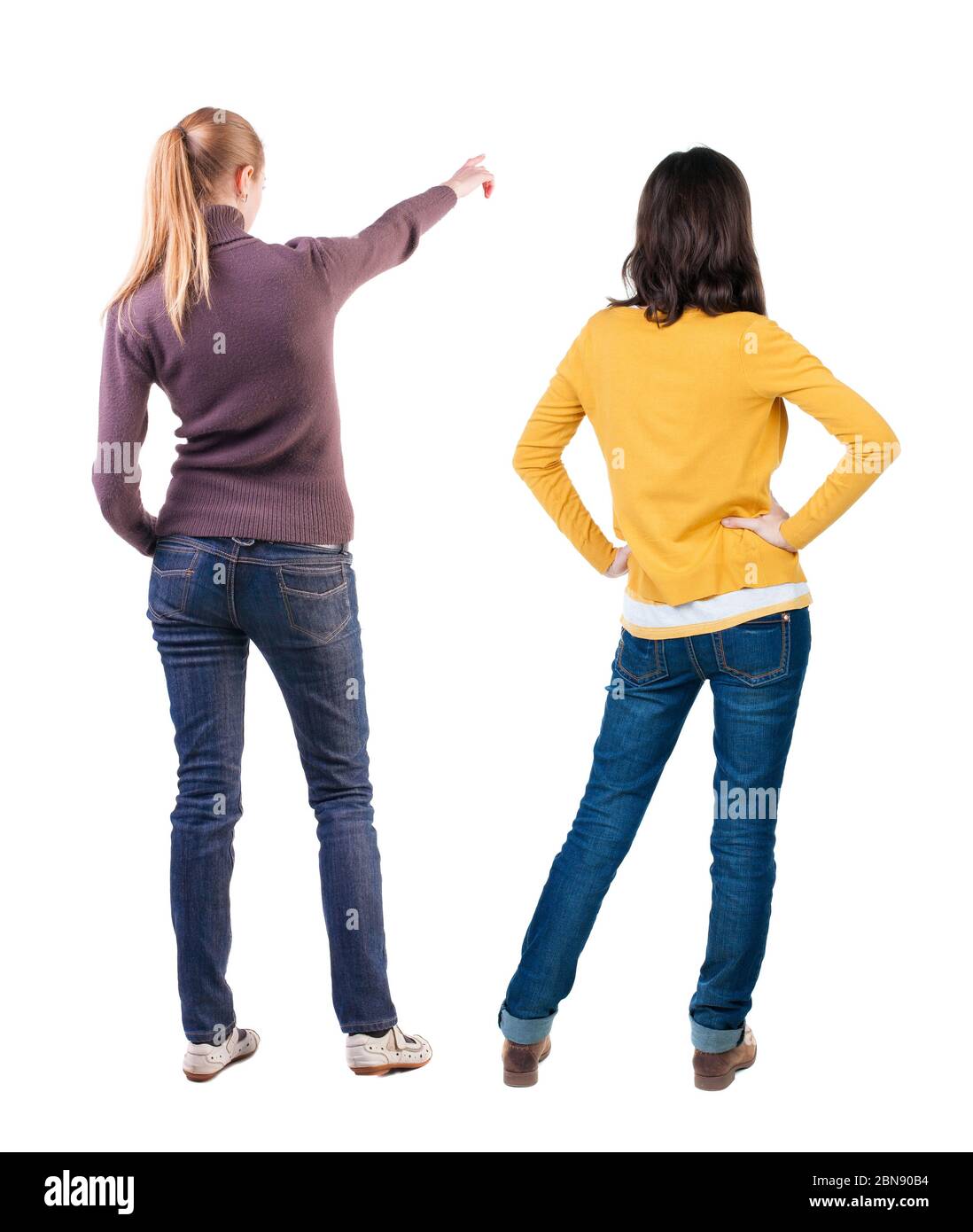 Back view of two pointing girl in sweater. Rear view people collection ...