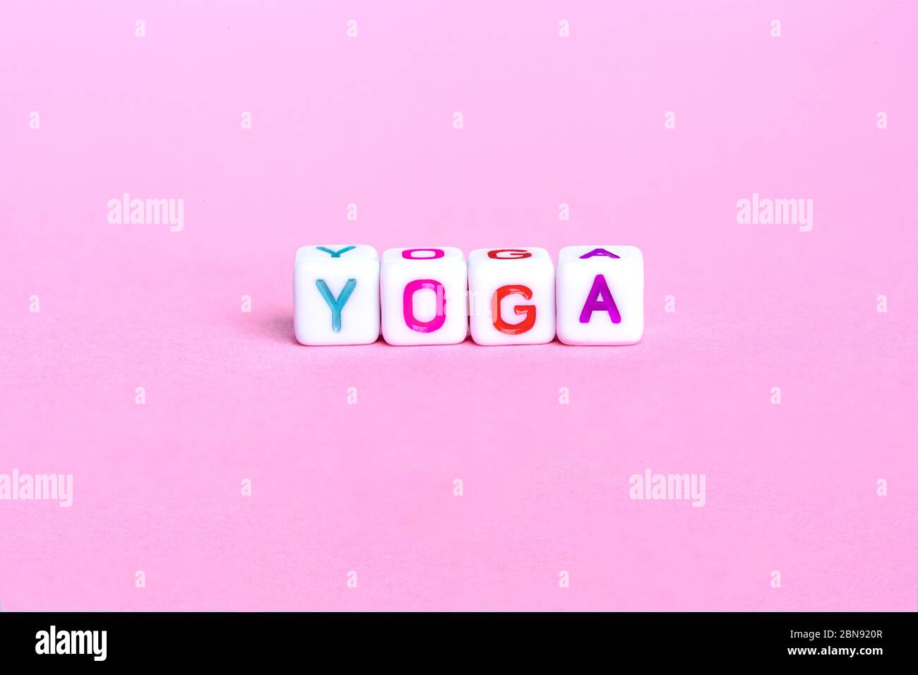 The word Amore - love in Italian.with text yoga on a pink background ...