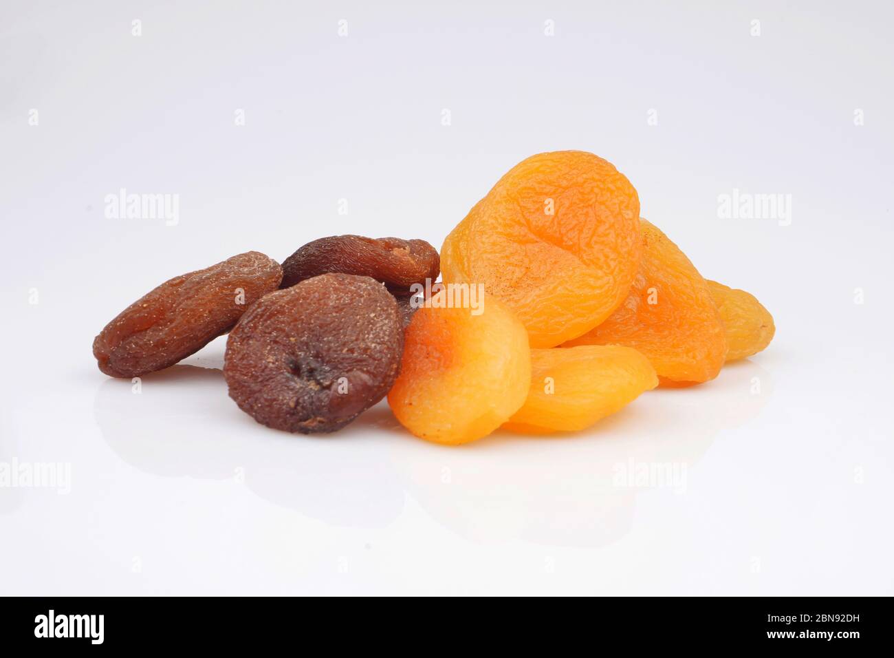 Organic and fresh dried black and yellow mix apricot close-up isolated ...