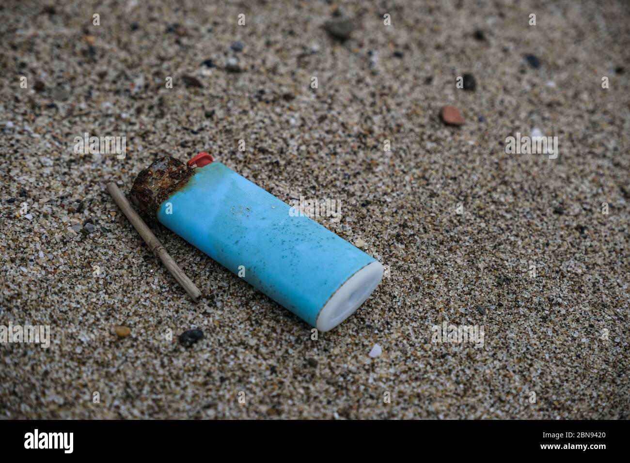 Salt Corroded Plastic lighter trash on sandy sea ecosystem ...