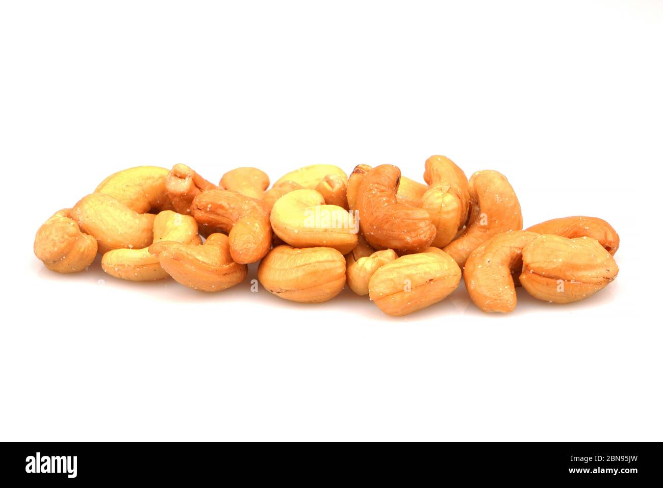 Organic cashew nuts heap on white background Stock Photo - Alamy