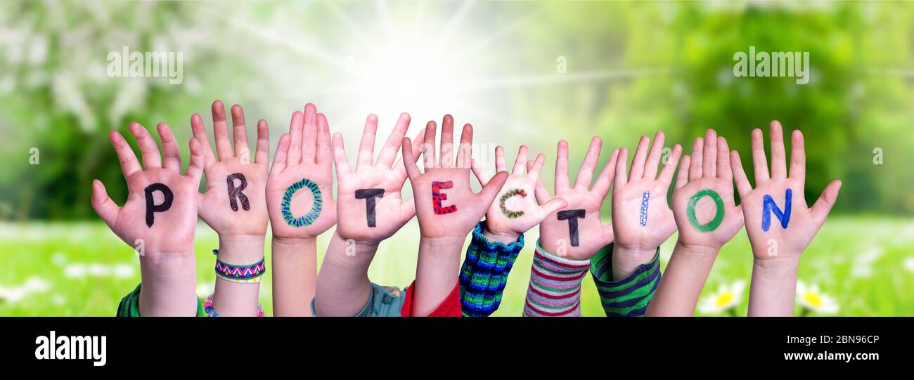 Kids Hands Holding Word Protection, Grass Meadow Stock Photo - Alamy