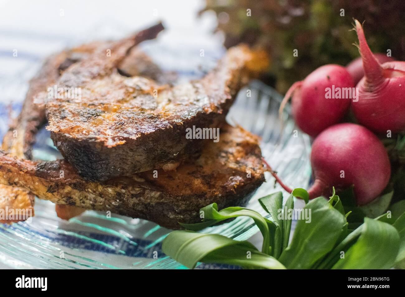 Freshly grilled fish on kitchen table. closeup and top view Stock Photo ...