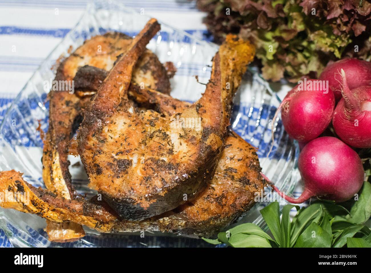 Freshly grilled fish on kitchen table. closeup and top view Stock Photo ...