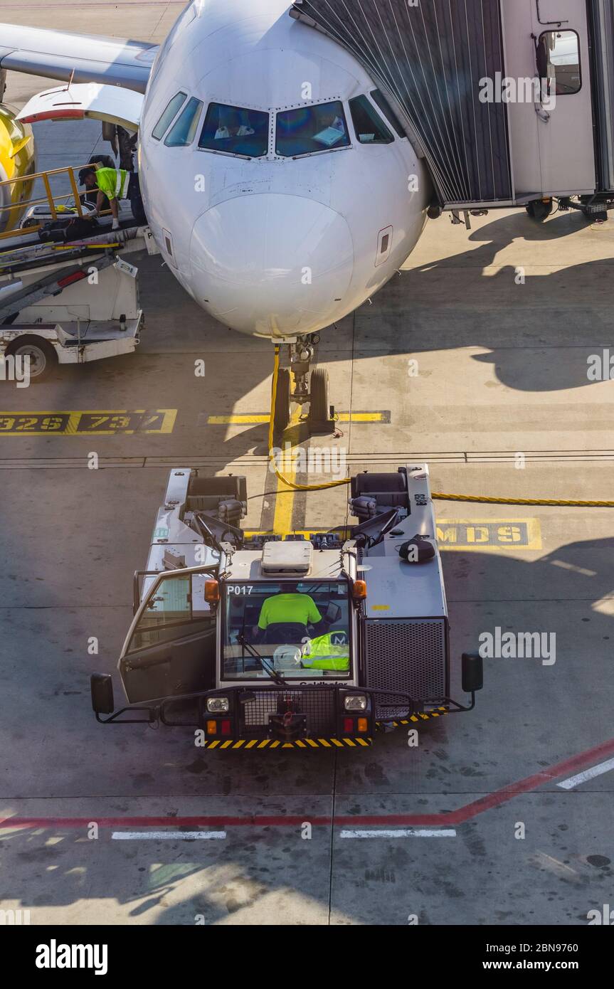 Aircraft being loaded at an airport on a day Stock Photo - Alamy