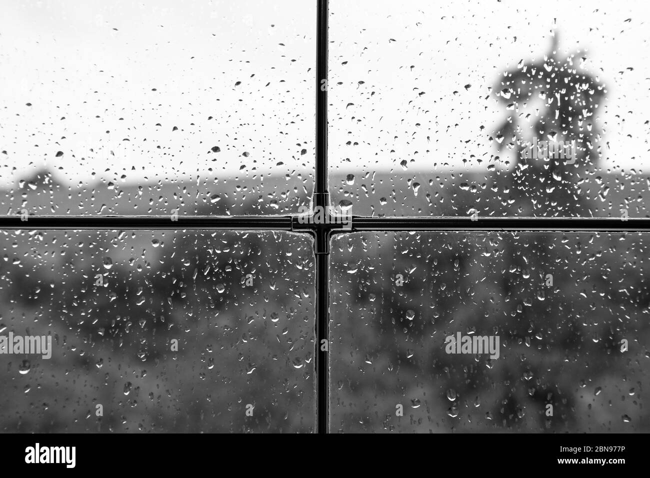 Rainy weather behind wet glass of a house window Stock Photo - Alamy