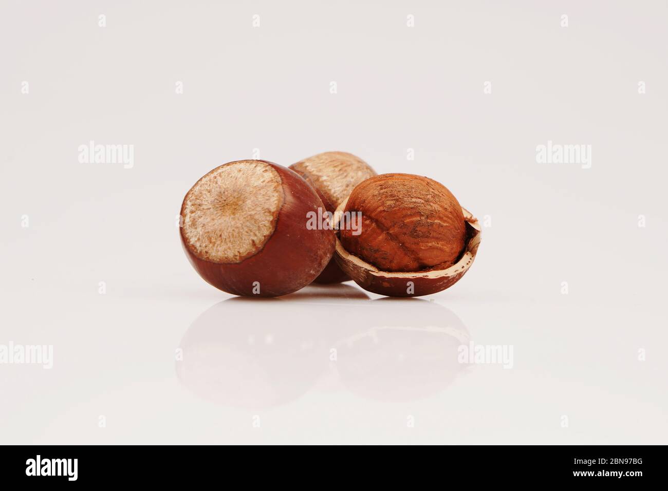 Organic and fresh two shelled and unshelled hazelnuts on white ...