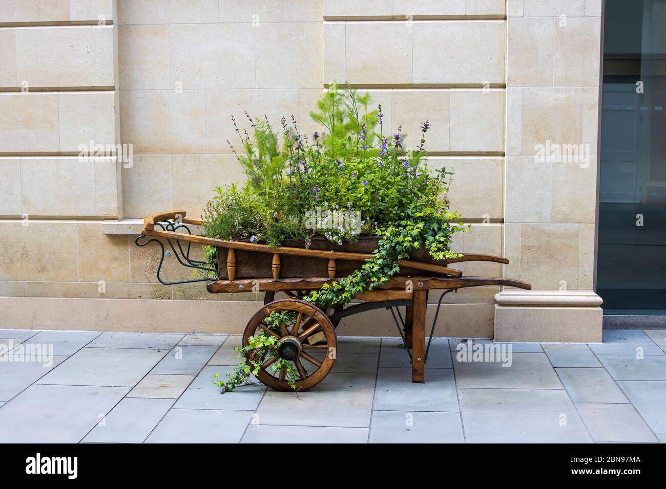 Wheelbarrow Floral Arrangement at Southgate, Bath Stock Photo - Alamy