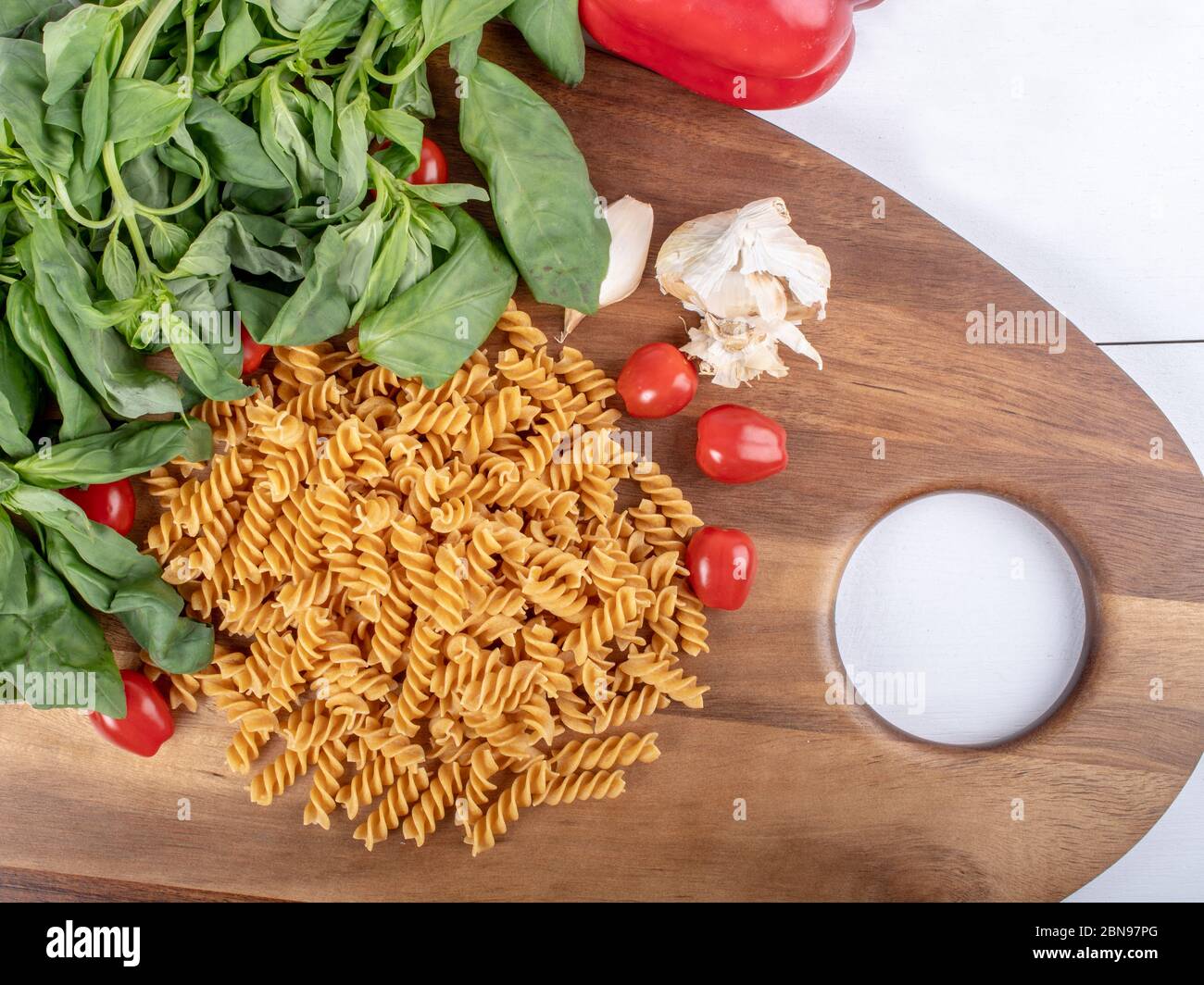 Gluten-free penne pasta from chickpeas, red lentils on wooden cutting ...
