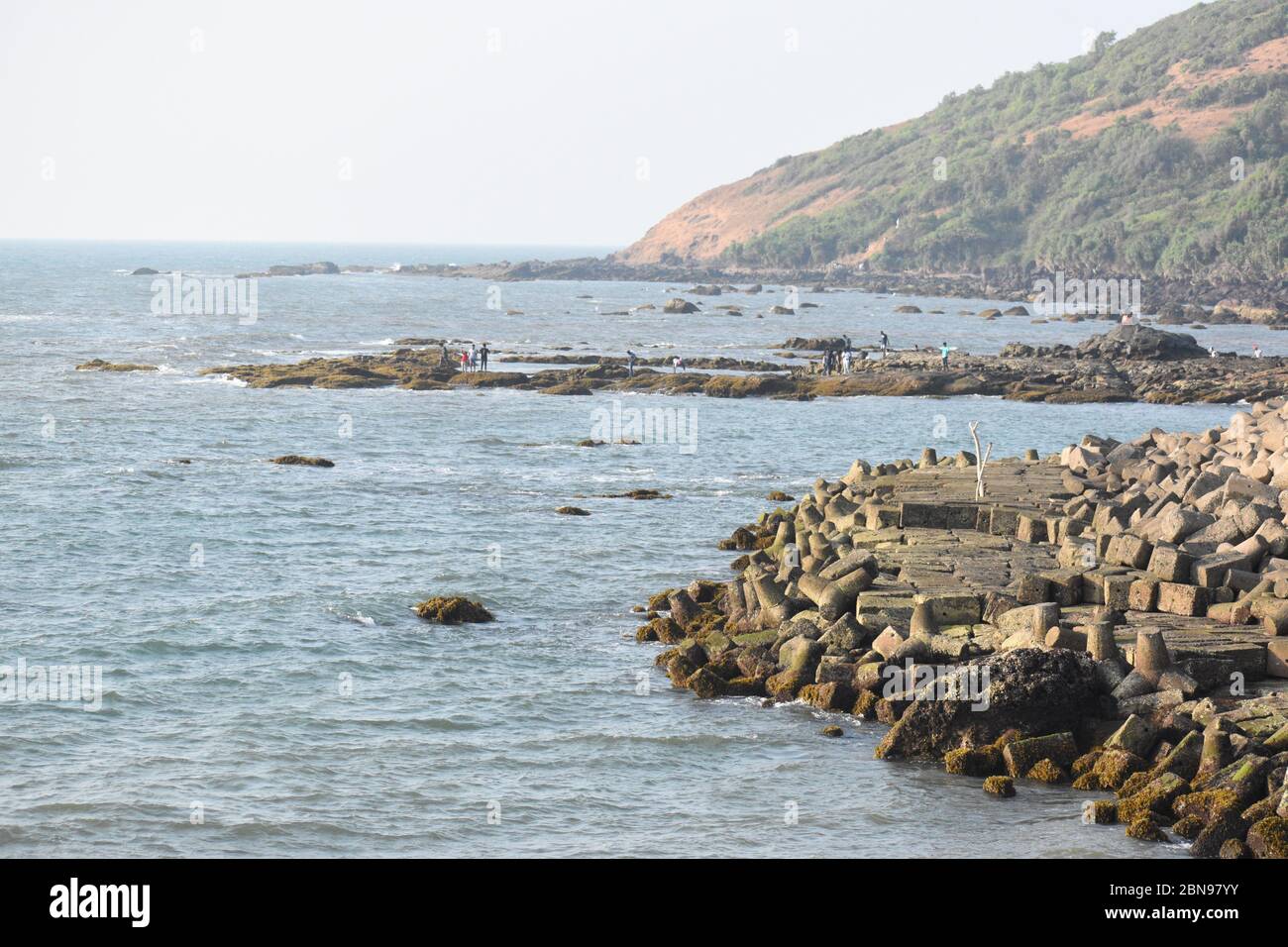 Black rocks in the seashore and mountain in the background..A view from ...