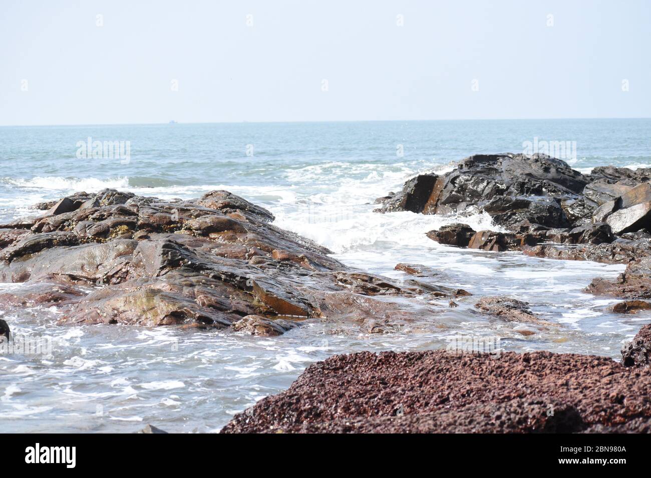 Sea waves hitting the rocks.Anjuna beach,Goa,India Stock Photo - Alamy