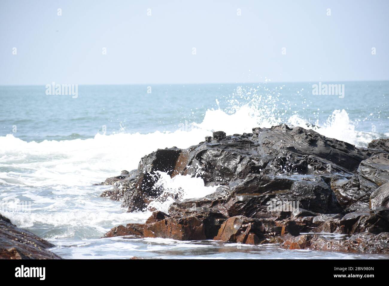 Sea waves hitting the rocks.Anjuna beach,Goa,India Stock Photo - Alamy
