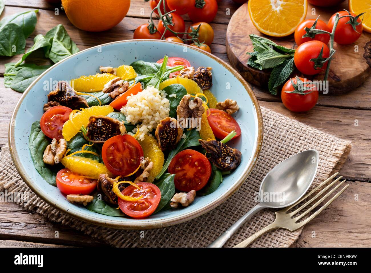 Colorful summer sweet salad with spinach, orange, cherry tomatoes ...