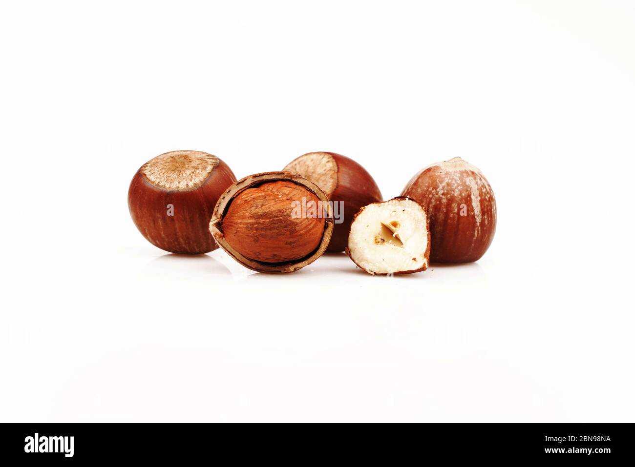Organic and fresh shelled groats and half hazelnuts on white background ...