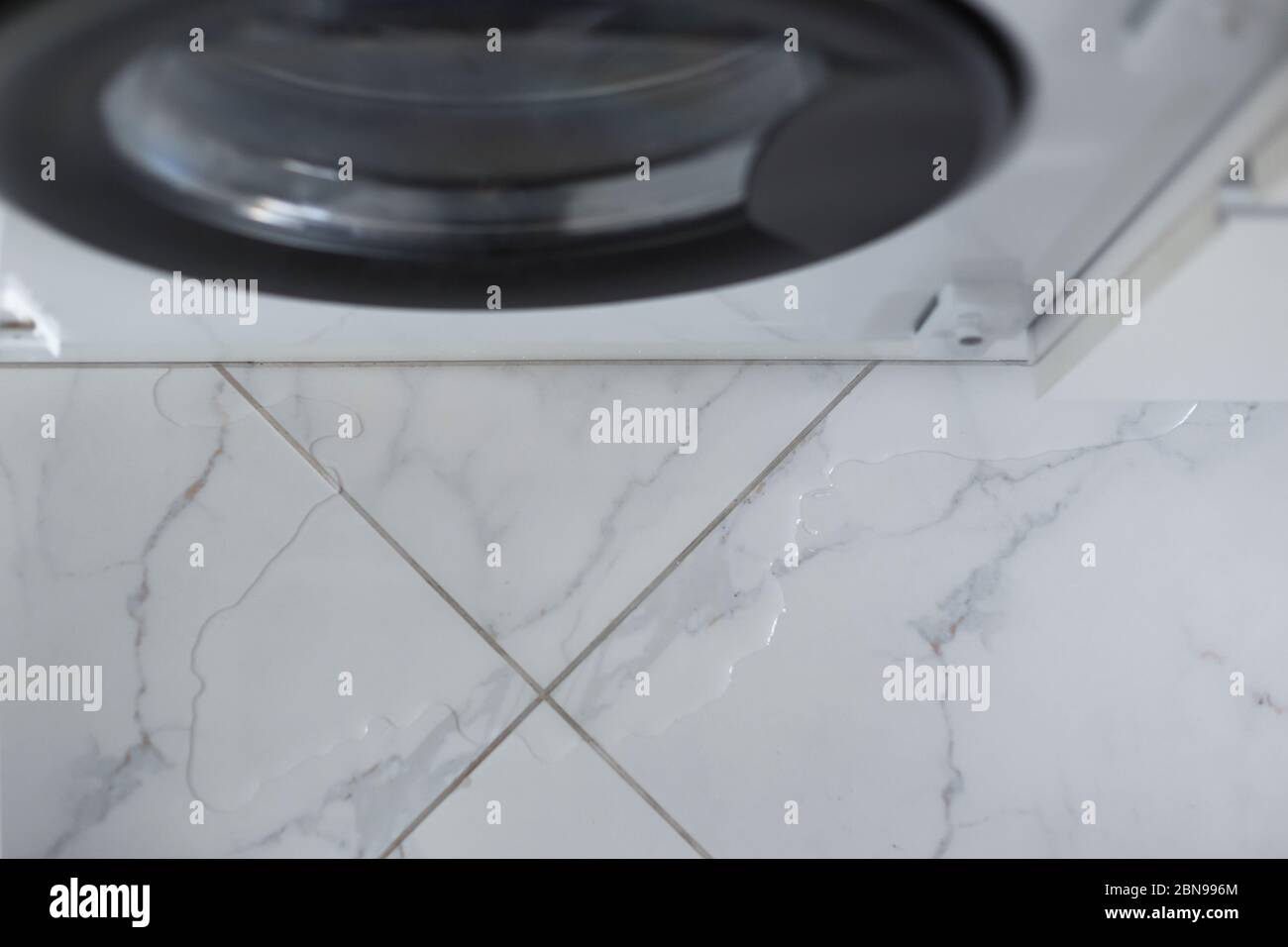Spilled water leaked from washing machine built into the kitchen ...