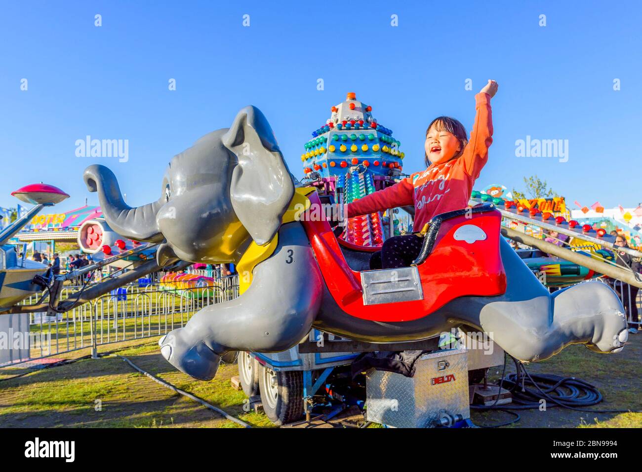 Young Asian girl enjoying Carnival Fun Fair Ride Stock Photo - Alamy