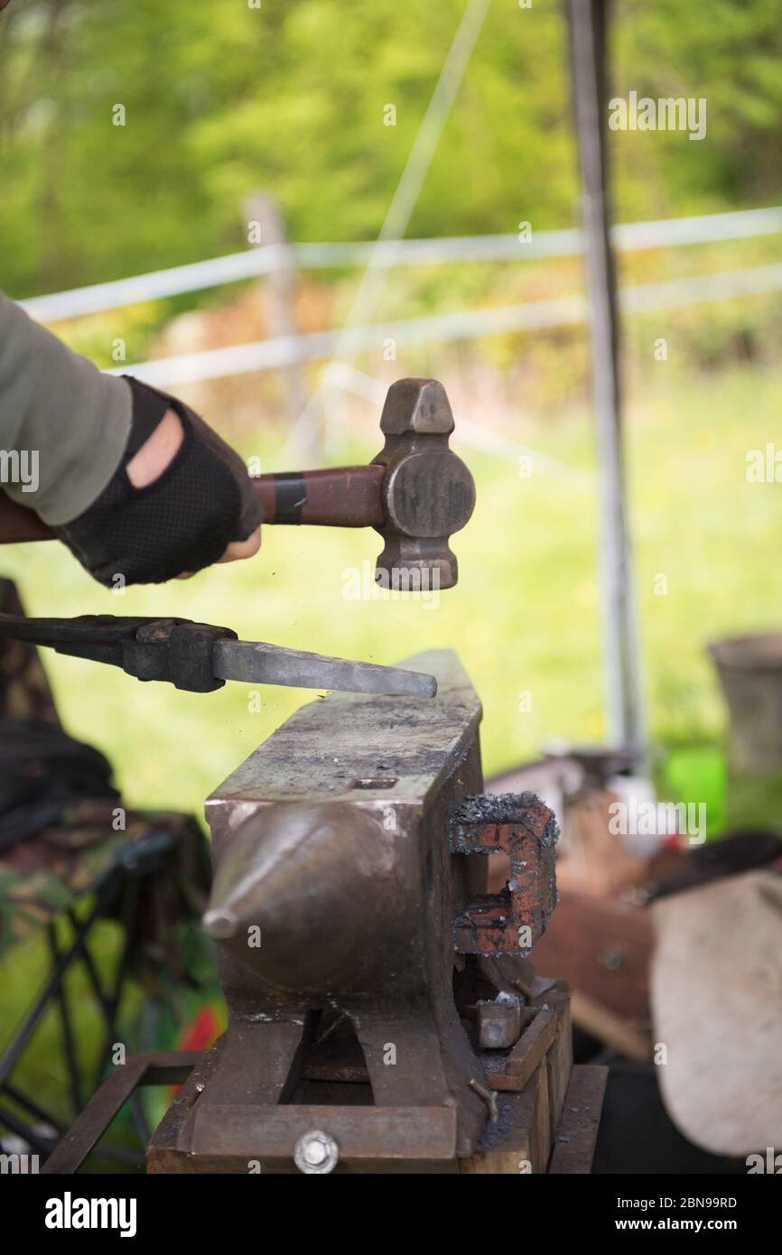 Blacksmith outdoor with hammer and anvil Stock Photo - Alamy