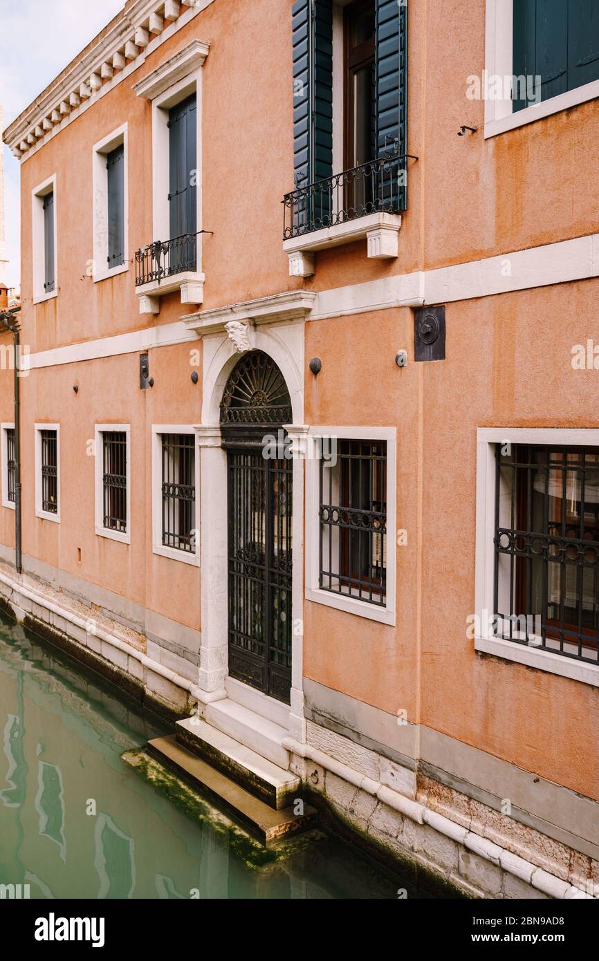 Close-ups of building facades in Venice, Italy. A two-story building ...